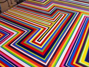 Modern Floor Decoration with Tape Strips Creating Cool Rainbow Design